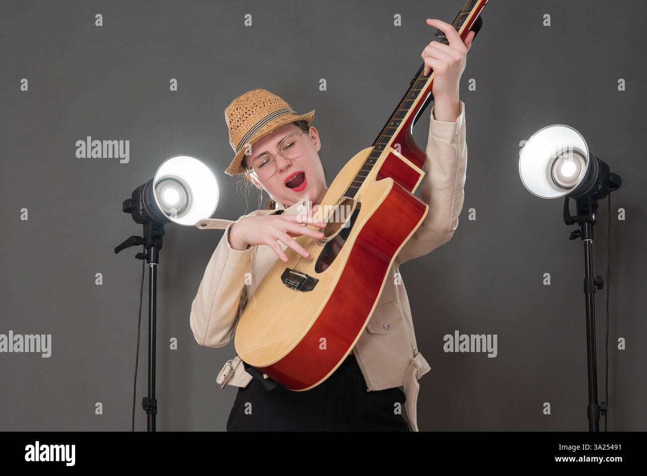 Playful woman guitarist and singer songwriter playing Spanish six ...
