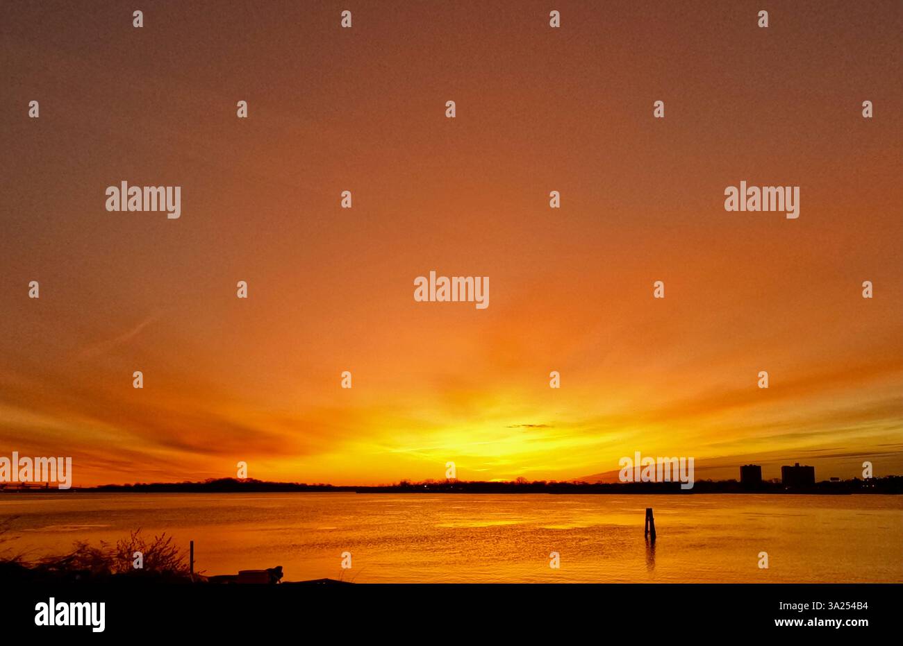 The sun rises over the Delaware River and the New Jersey shoreline, as ...