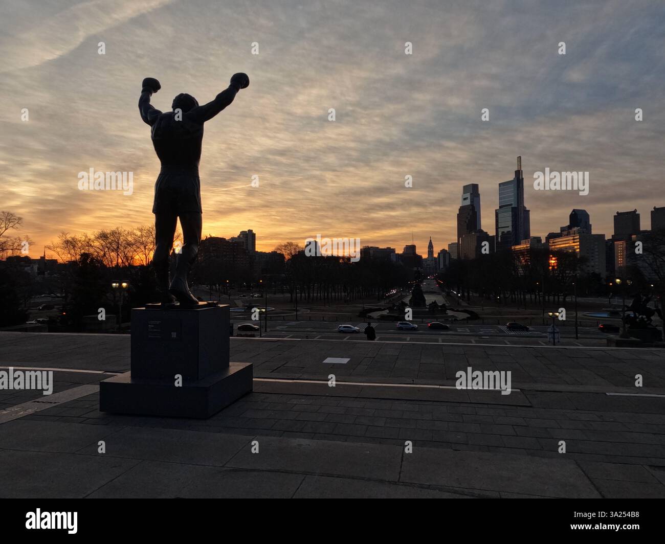 The sun rises behind the Rocky statue atop the Philadelphia Museum of ...