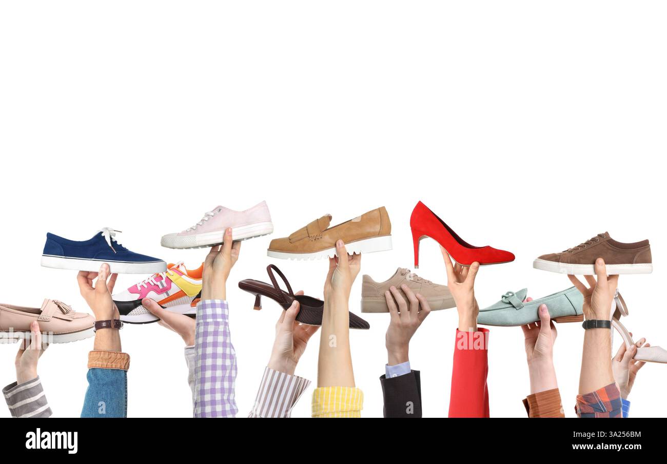 People holding different shoes in hands on white background, closeup ...