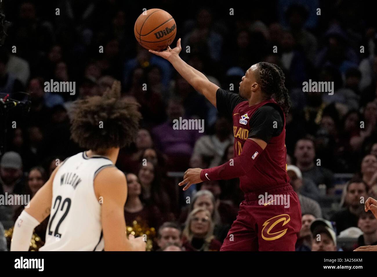 Cleveland Cavaliers guard Darius Garland, right, shoots in front of ...