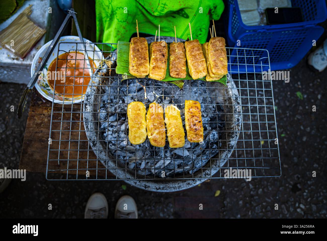 Grilled snacks on a charcoal grill in Luang Prabang, Laos. This image ...