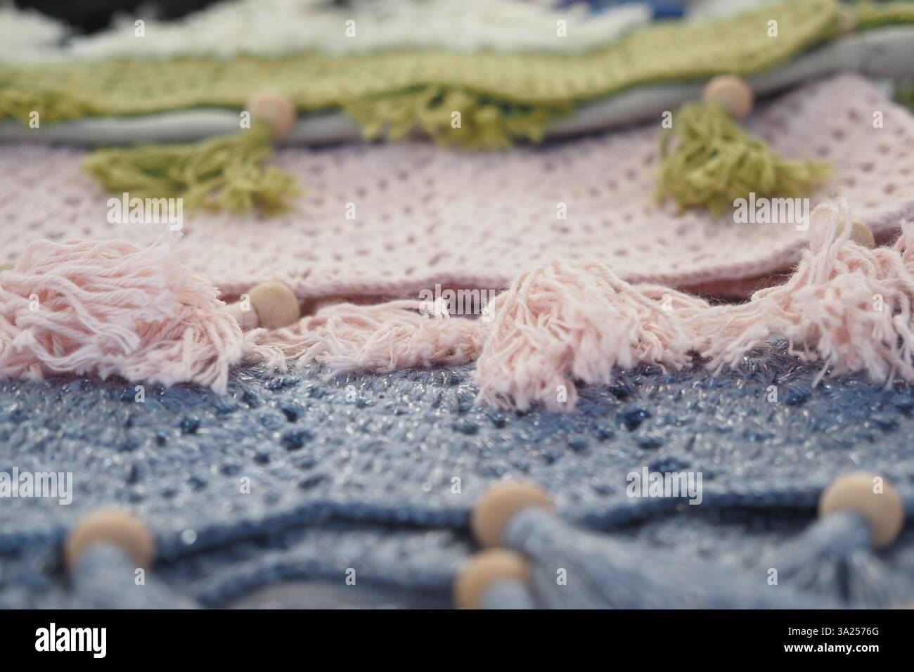 Colorful handmade textiles with fringes and beads on display Stock ...