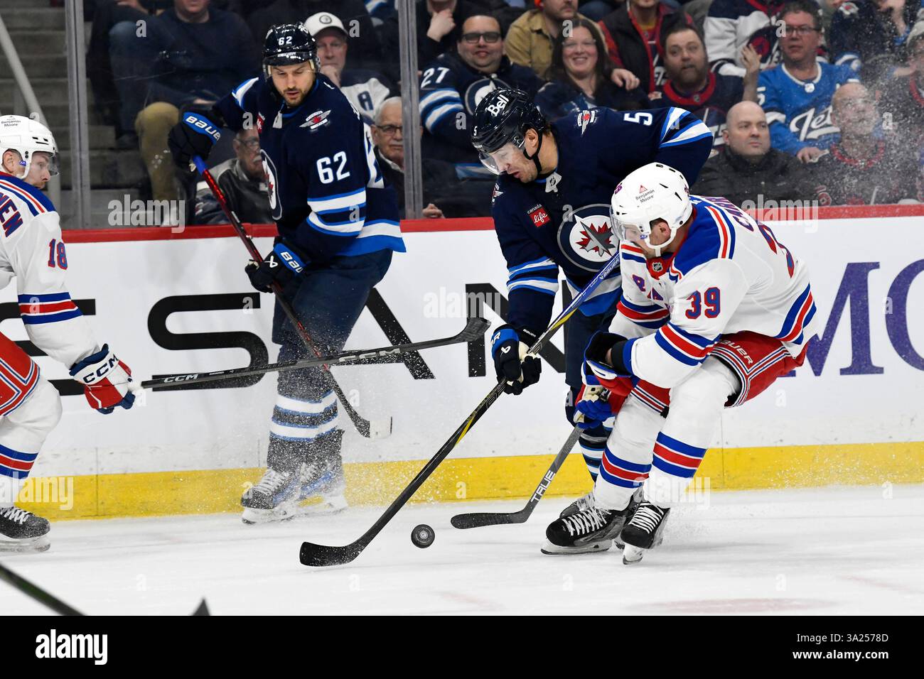 New York Rangers' Sam Carrick (39) and Winnipeg Jets' Luke Schenn (5 ...