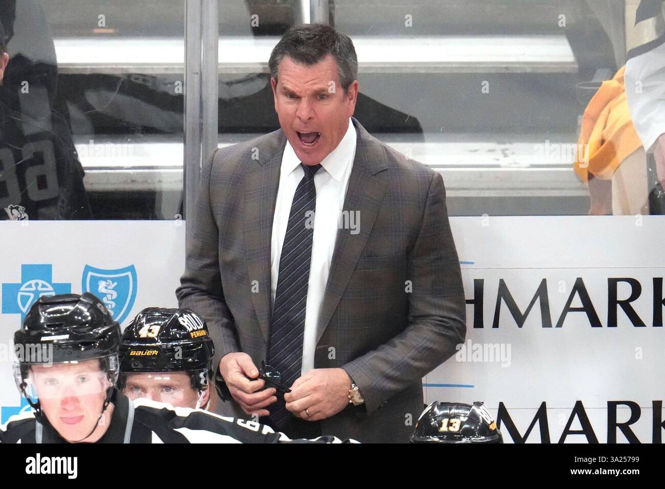 Pittsburgh Penguins head coach Mike Sullivan stands behind his bench ...