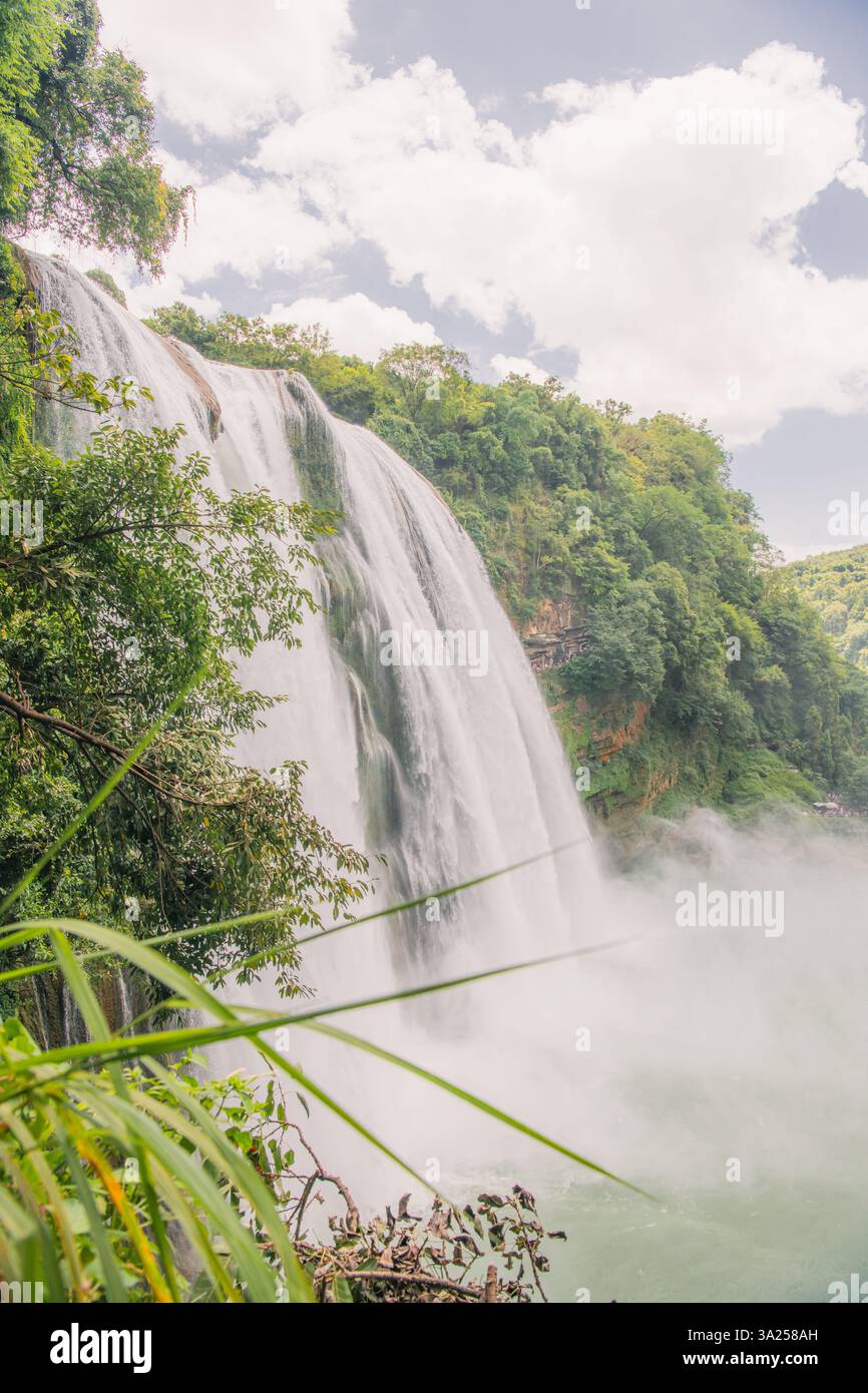 The waterfall interrupts violently the peaceful continuous flow of the ...