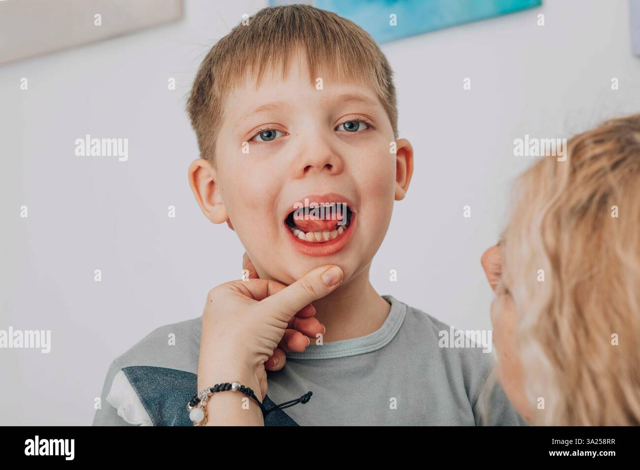 boy, tongue movement during speech therapy session, receiving ...