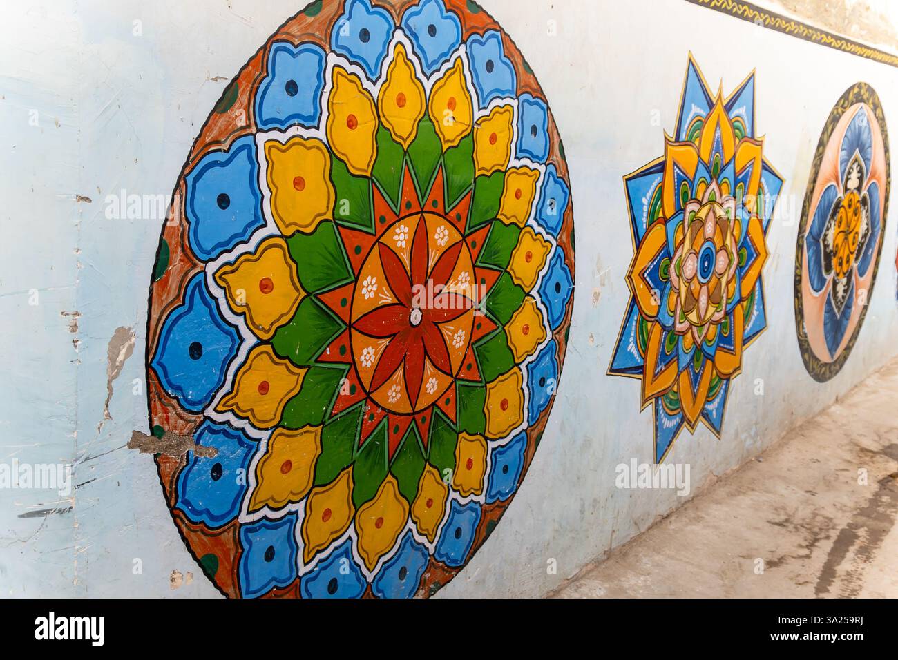 artistic wall painting of hindu holy sign or chakras at city street at ...