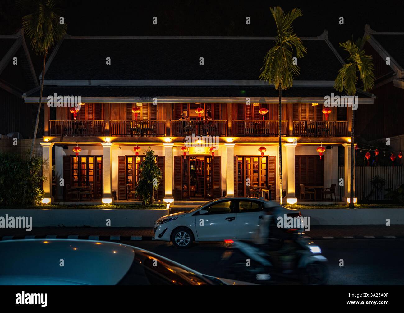 A charming building illuminated at night in Southeast Asia. This image ...