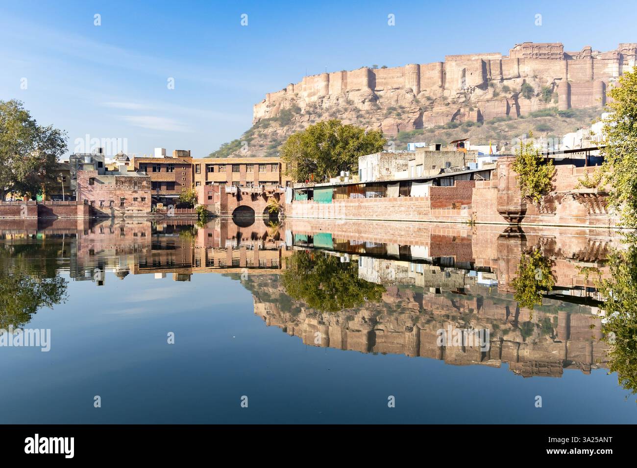 pristine calm lake with water reflection of vintage architecture around ...