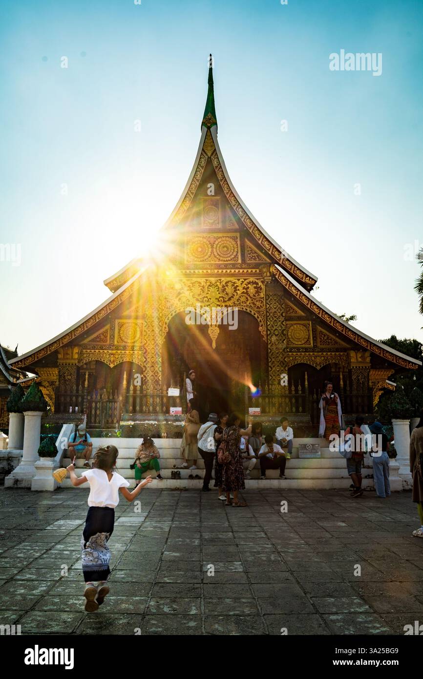 Wat Xieng Thong temple, Luang Prabang, Laos. Child running, golden ...