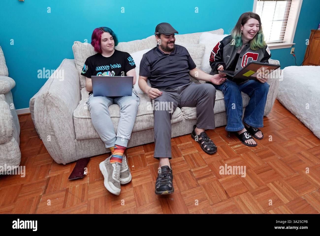 Tim Reiland, 42, center, the parent of daughter Zoe Reiland, 17, right ...