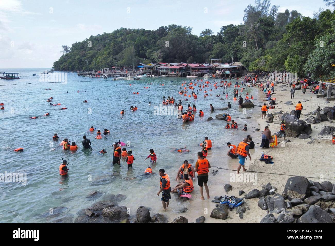 People swim in the water at Rubiah Beach, Weh Island, Aceh province ...