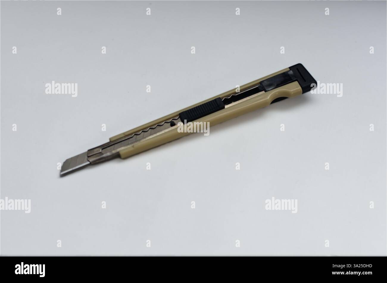 Gold and Black Utility Knife on a Neutral Background for Office Tasks ...