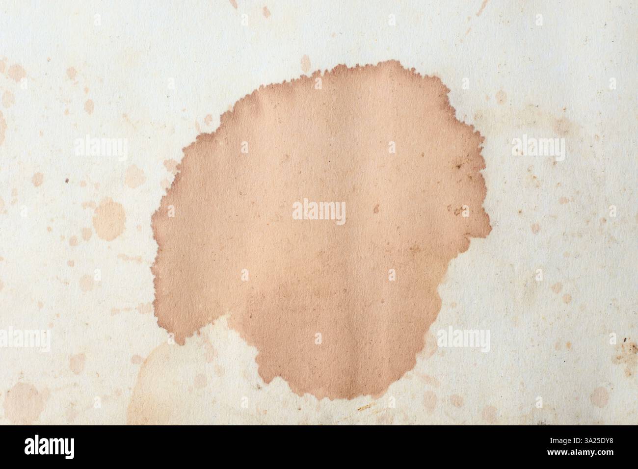 brown color coffee or tea stains on piece of old paper surface, close ...