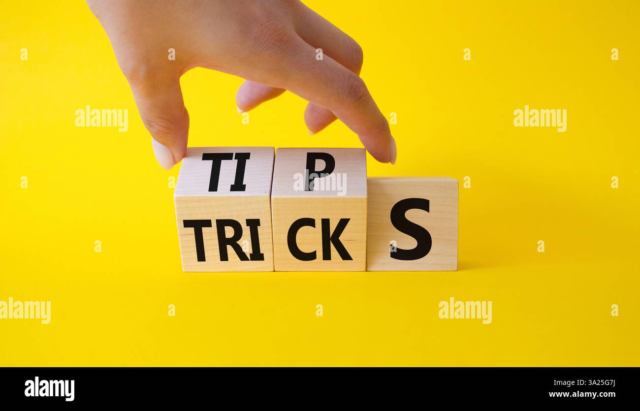 Tips and Tricks symbol. Businessman Hand turns cubes and changes word ...