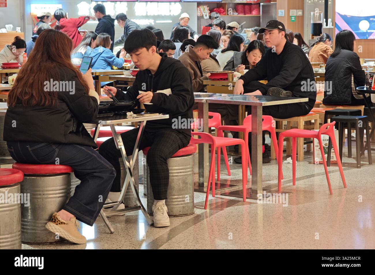SHANGHAI, CHINA - MARCH 12, 2025 - White-collar workers take a break to ...