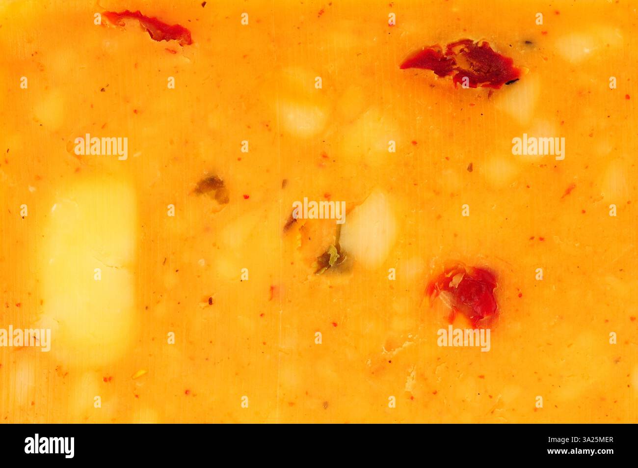 Cheddar cheese slice with mixed peppers and spices flavour background ...