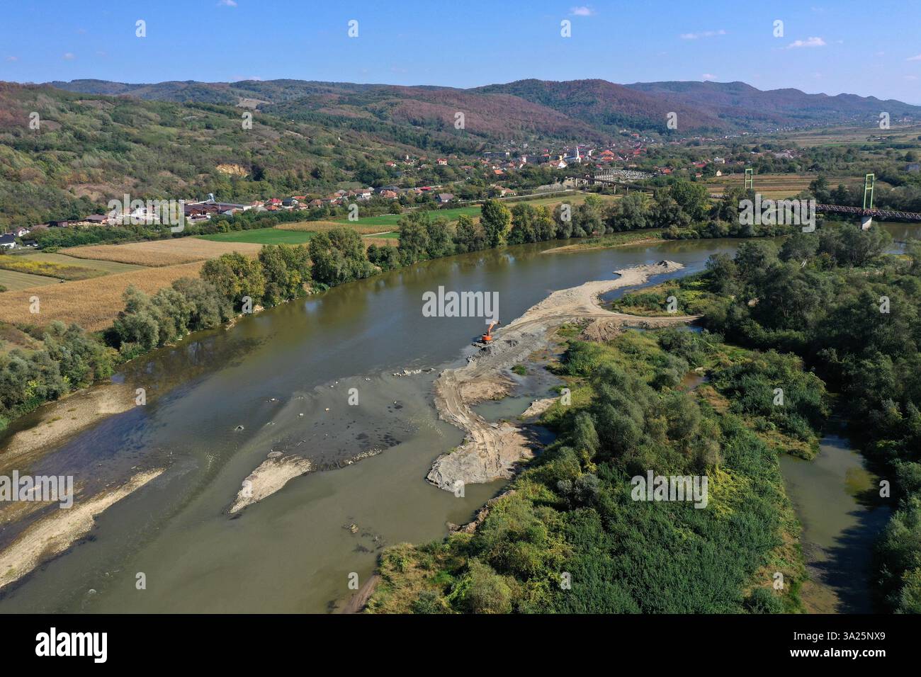 Aerial view of backhoes digging sand and gravel with shovels from the ...