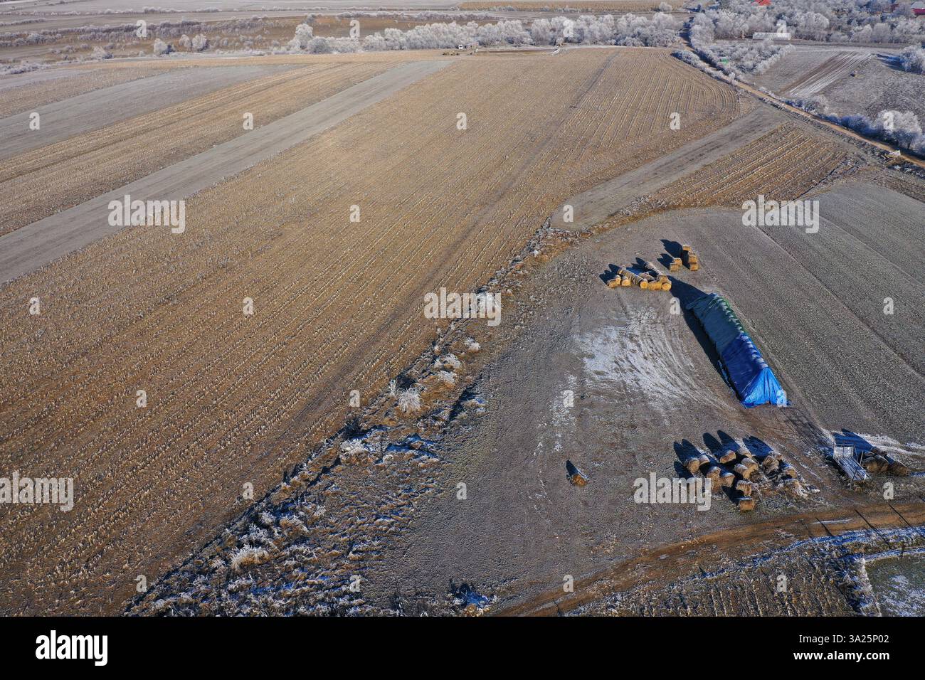 Aerial view of rural landscape showing farm fields, icy terrain, and ...