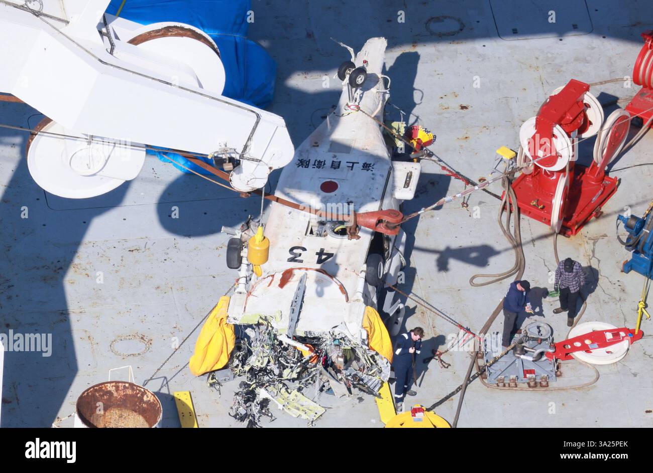 An aerial photo shows a Maritime Self-Defense Force helicopter salvaged ...