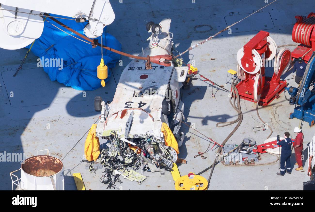 An aerial photo shows a Maritime Self-Defense Force helicopter salvaged ...