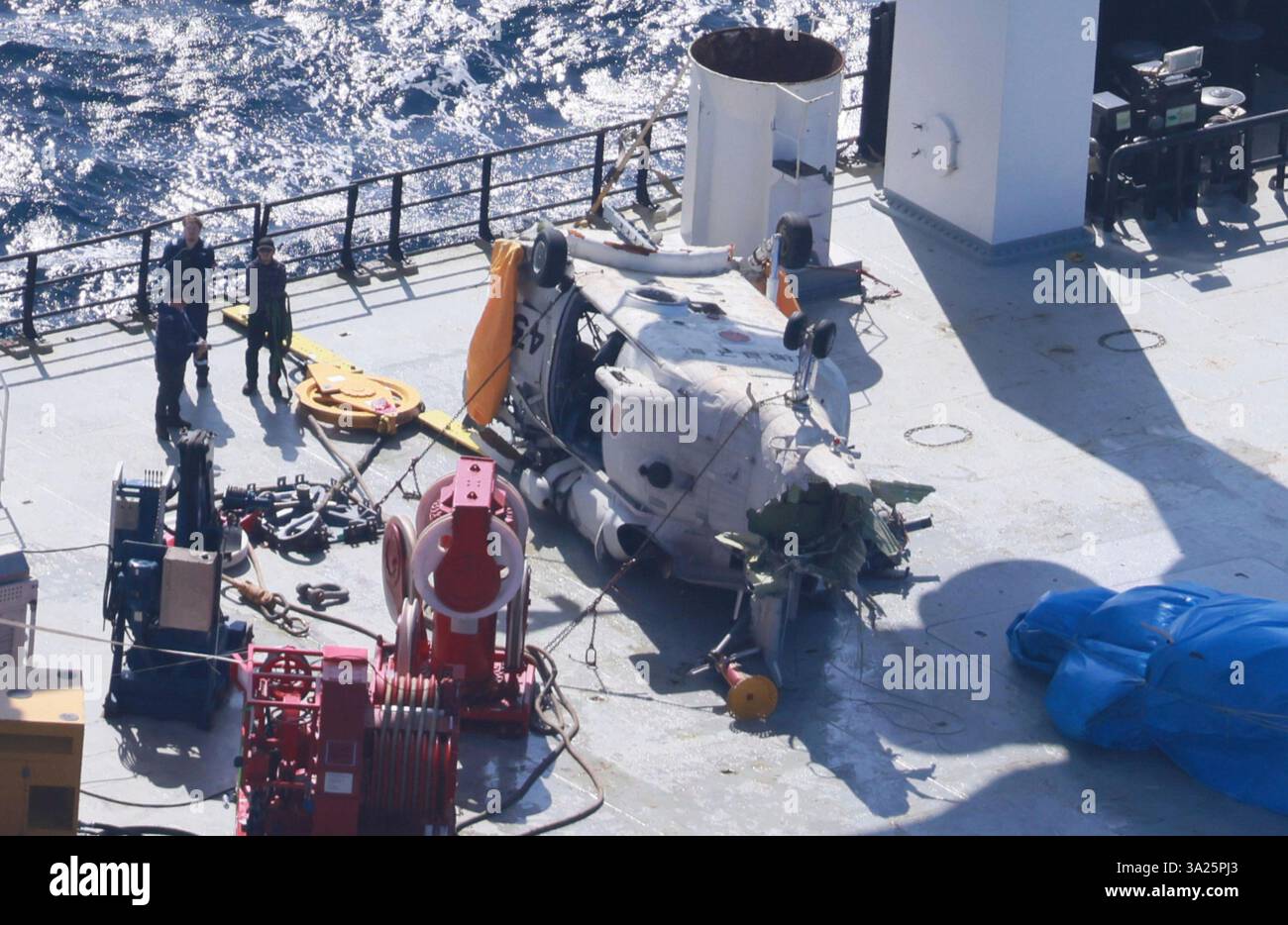 An aerial photo shows a Maritime Self-Defense Force helicopter salvaged ...