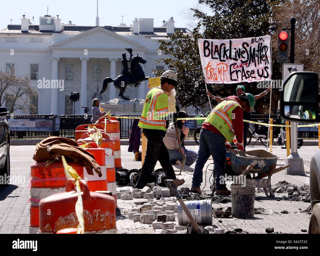 Crews work to remove the Black Lives Matter street mural in Washington ...
