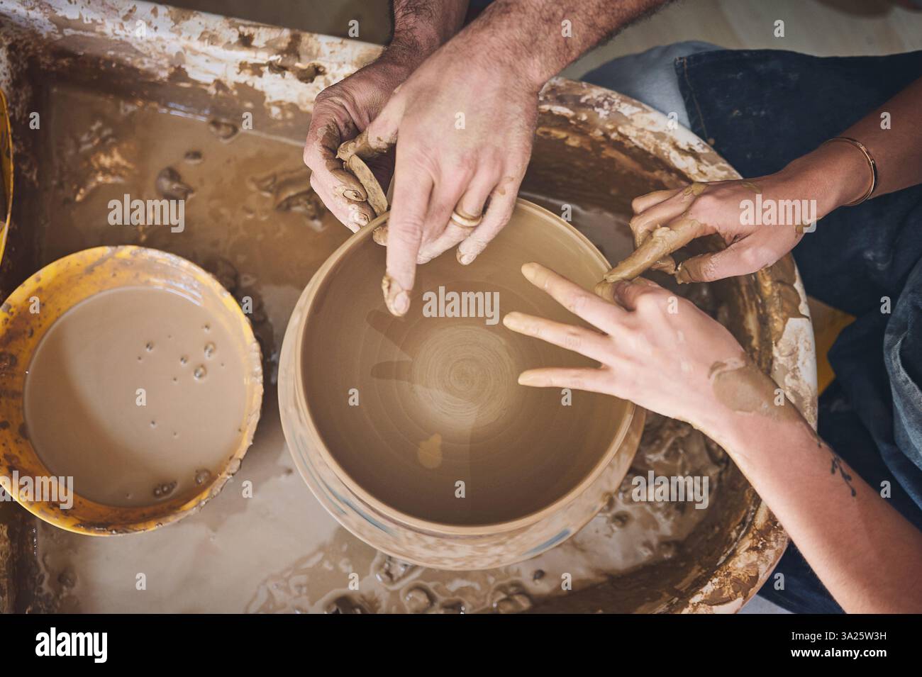People, hands and molding pottery in studio, working together and ...