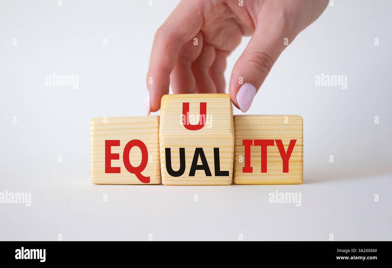 Equity and Equality symbol. Businessman hand turns wooden cubes and changes the word Equality to ...