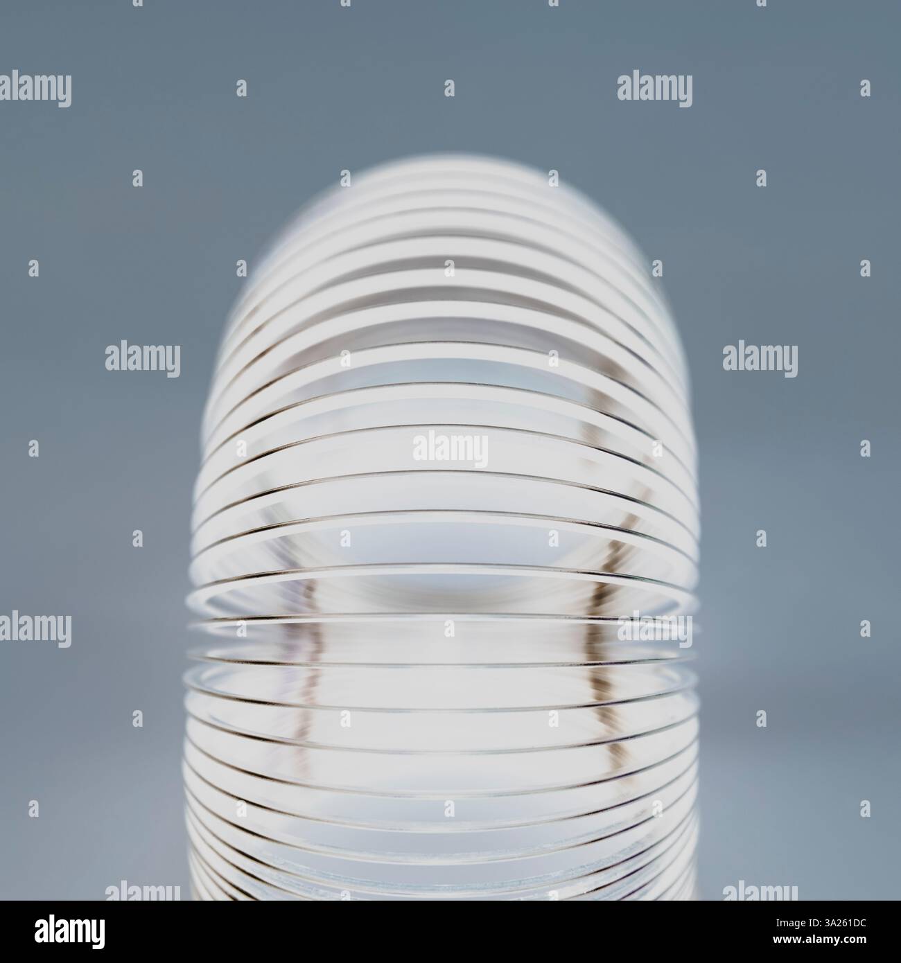 Abstract of metal coiled slinky, length of fine wire wound around and ...