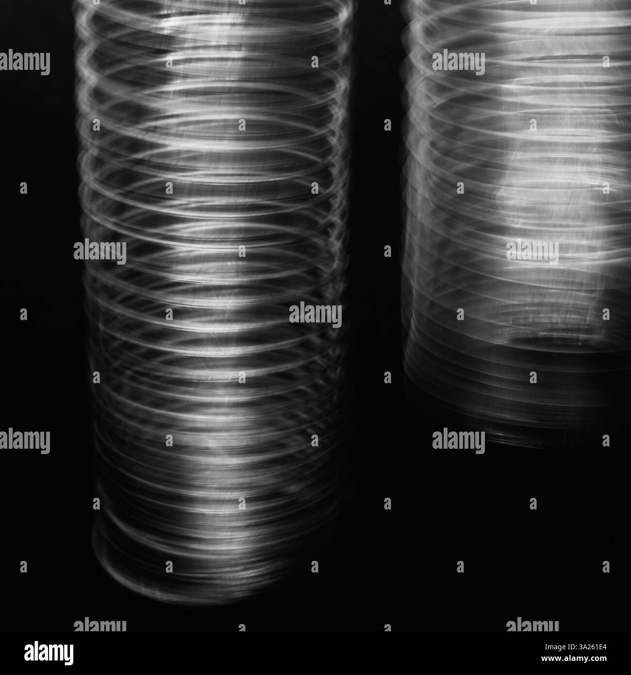 Abstract of metal coiled slinky, length of fine wire wound around and ...