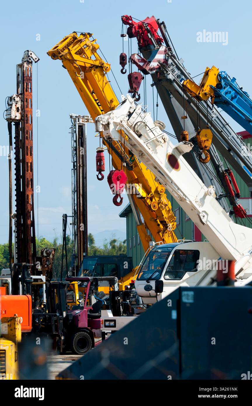 A group of mobile cranes with hooks and pulleys, dockyard lifting ...