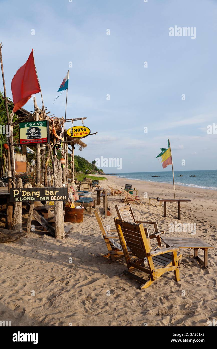 Beach bar and cabins on a sandy beach, with flags and furniture, on the ...