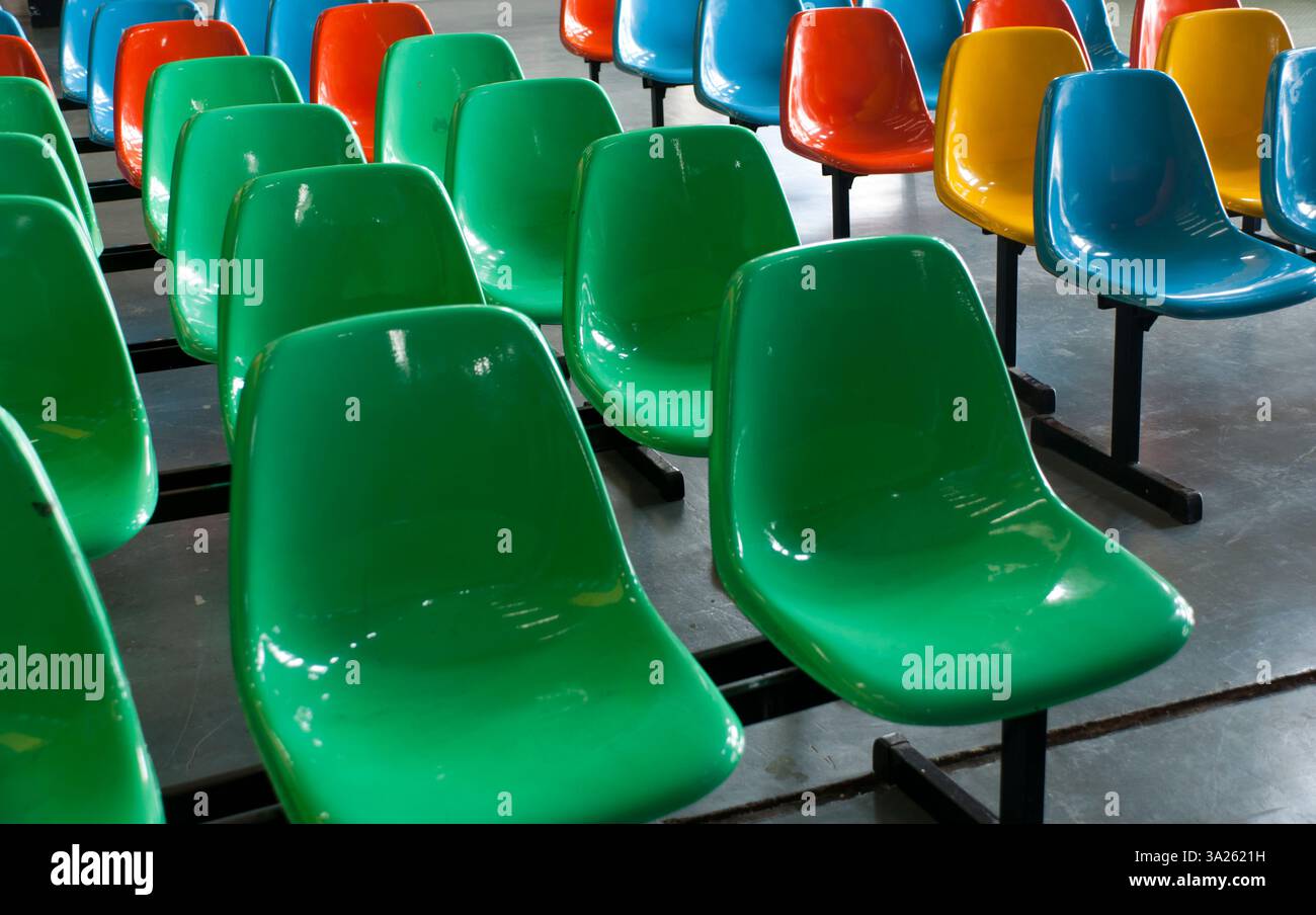 Fixed seats on a metal framework, plastic coloured shapes. Red, green ...