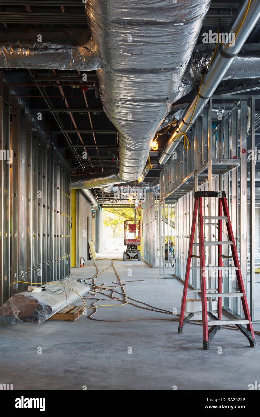 A commercial building under construction with roof ducts and light ...