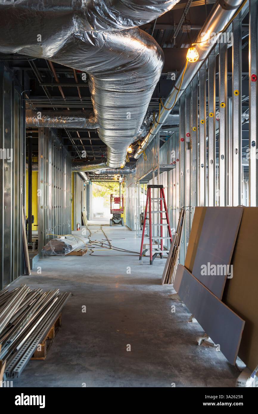 A commercial building under construction with roof ducts and light ...