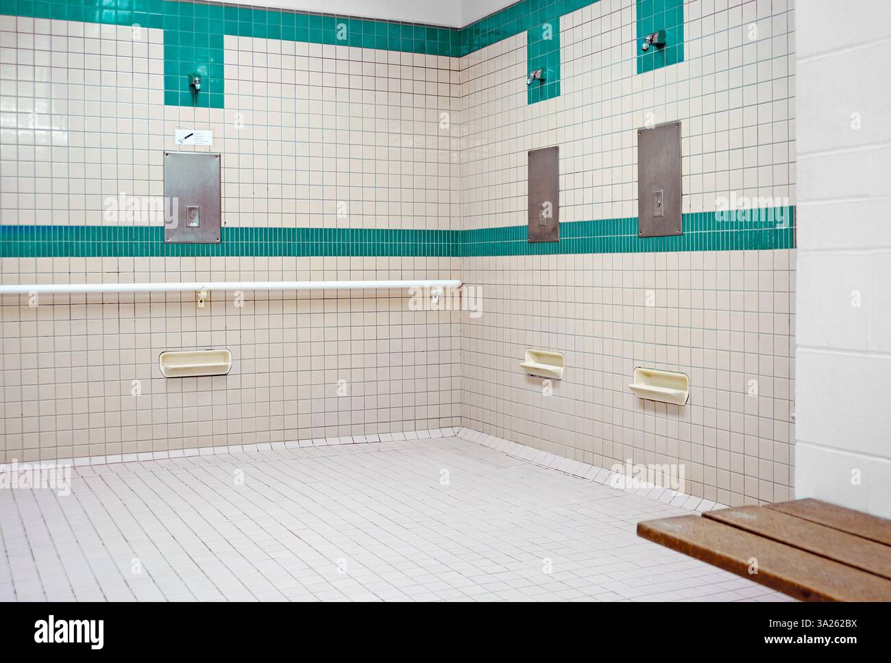Tiled public shower room for use before entering the swimming pool area ...