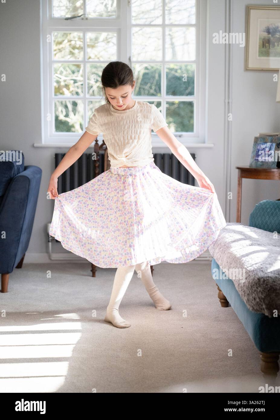 Girl facing camera curtseying in sitting room with head down Stock ...