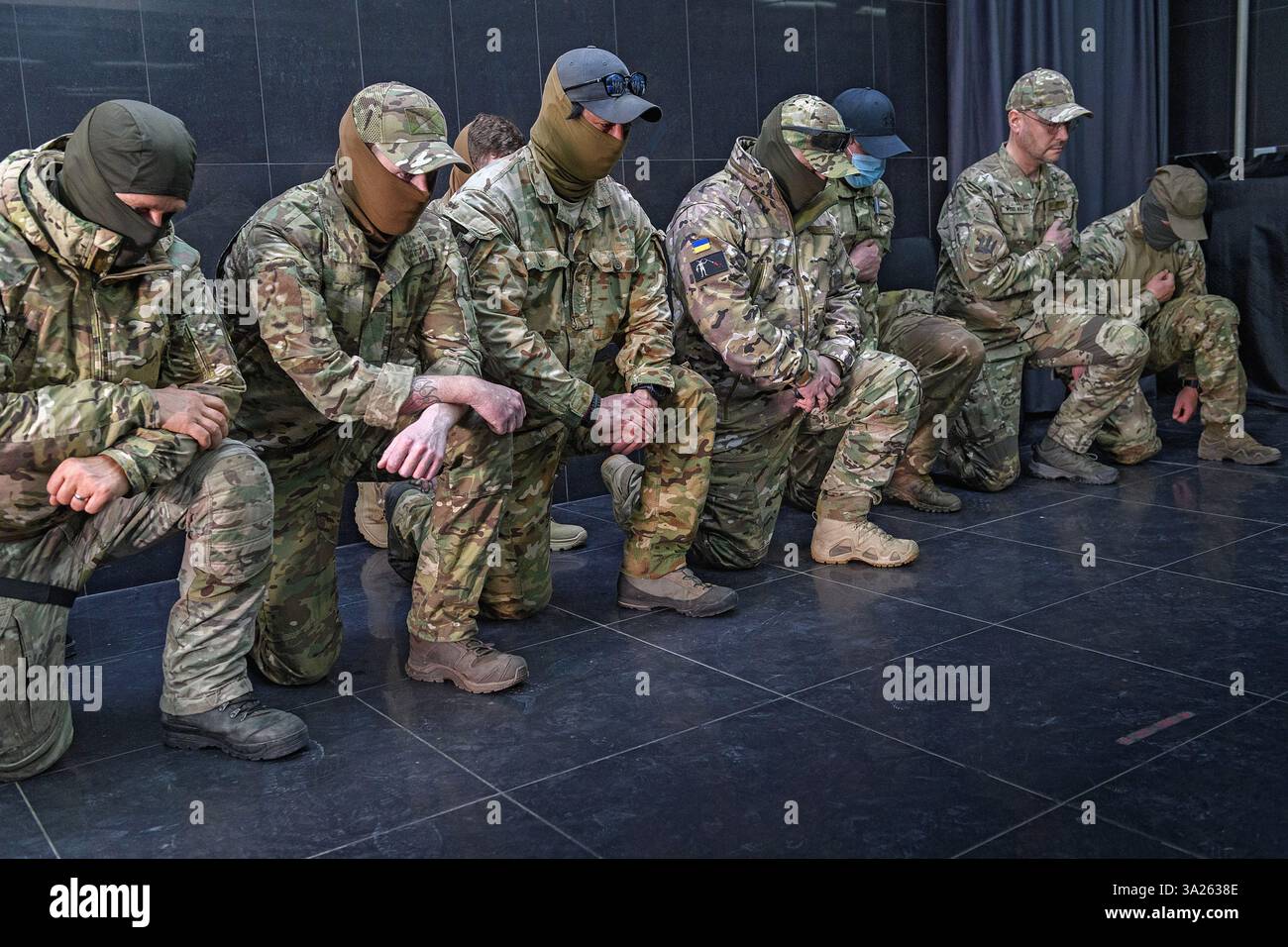 Soldiers kneel during a memorial ceremony for Dominic Bryce Abelen, a ...