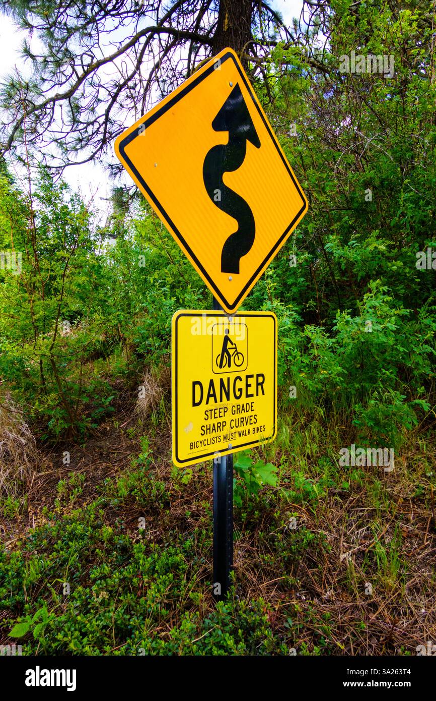 Curvy arrow road sign and warning of steep grade, Spokane, WA USA Stock ...