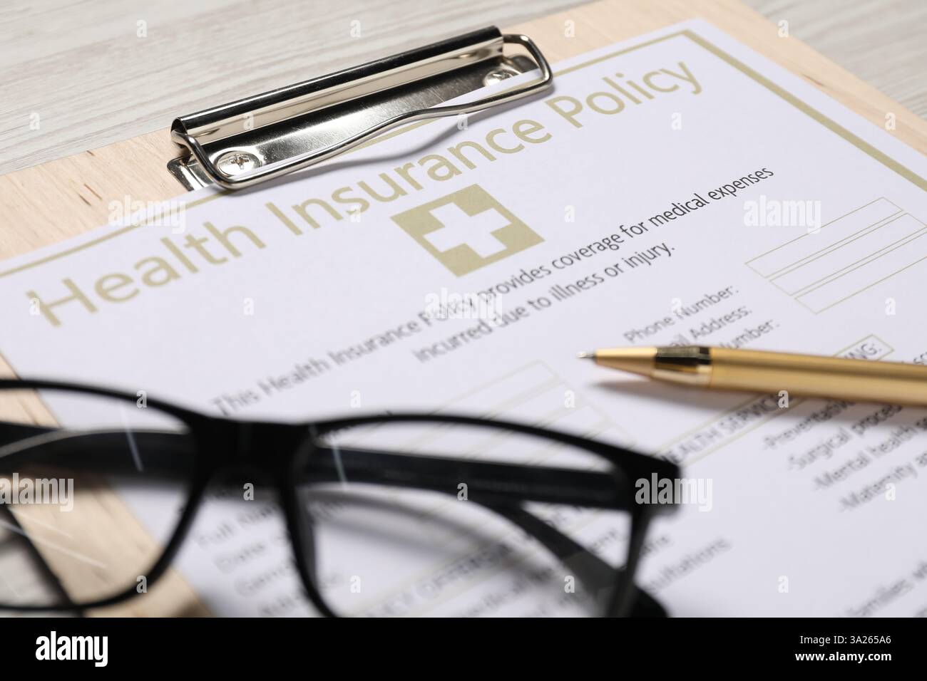 Health insurance policy form, glasses and pen on table, closeup Stock ...