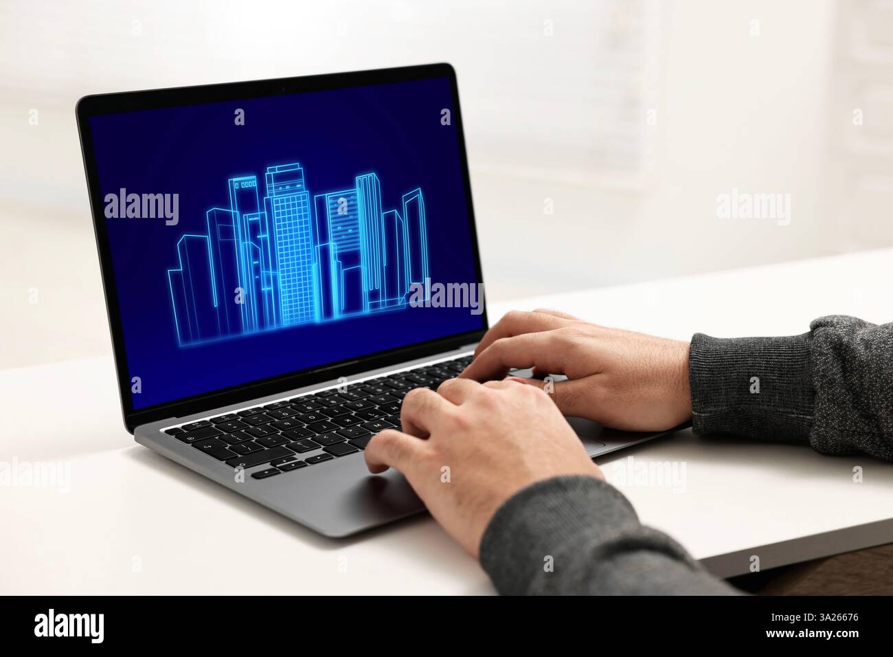 Building information modeling. Man working at laptop indoors, closeup ...