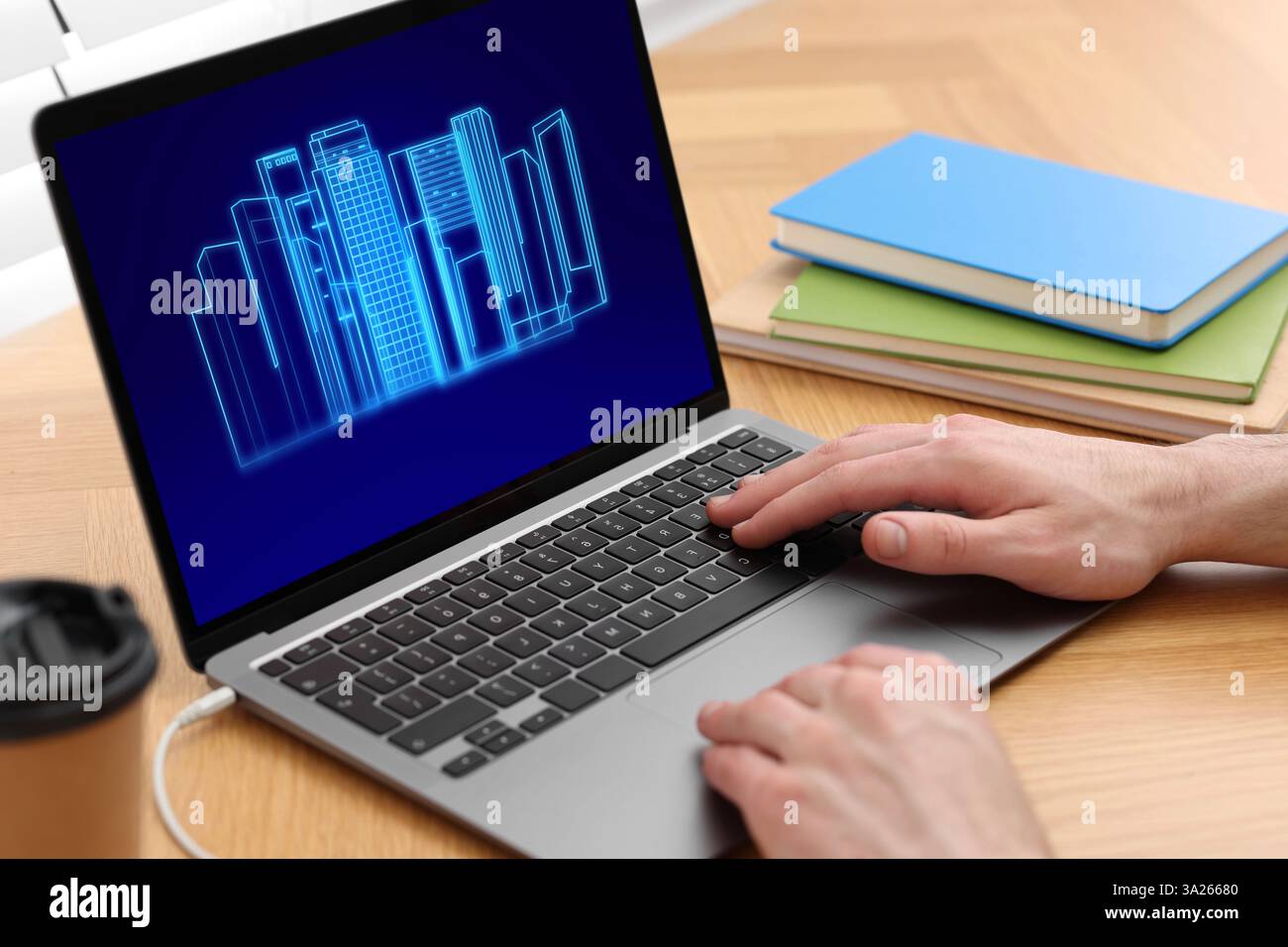 Building information modeling. Man working at laptop indoors, closeup ...