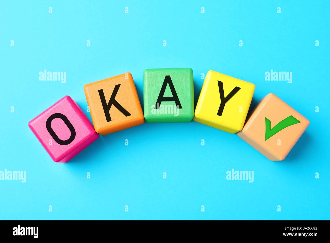 Colorful cubes with word Okay and check mark on light blue background ...