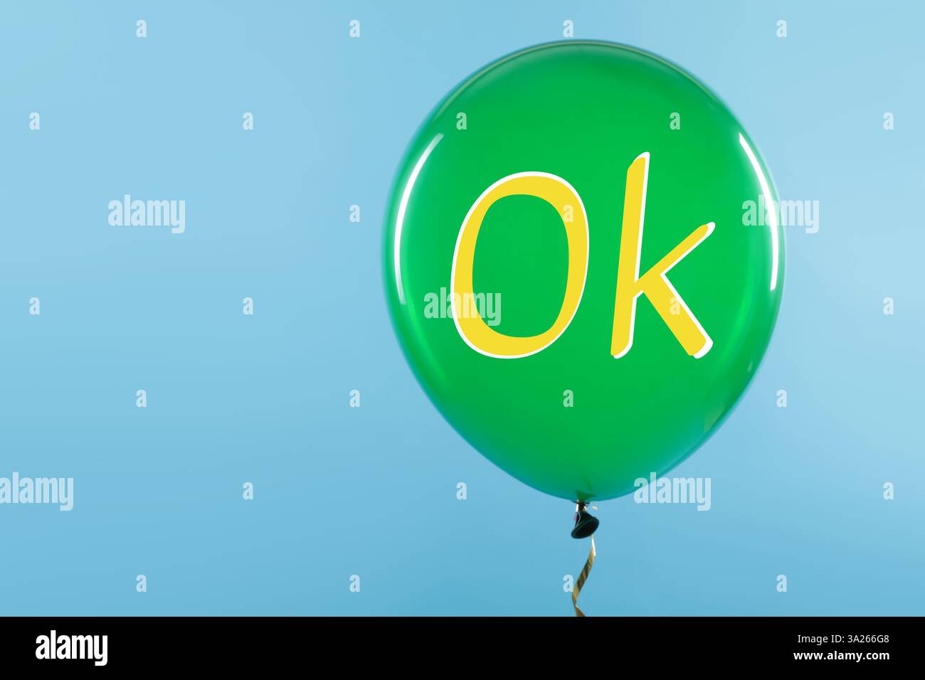 Green balloon with abbreviation OK on light blue background, space for ...