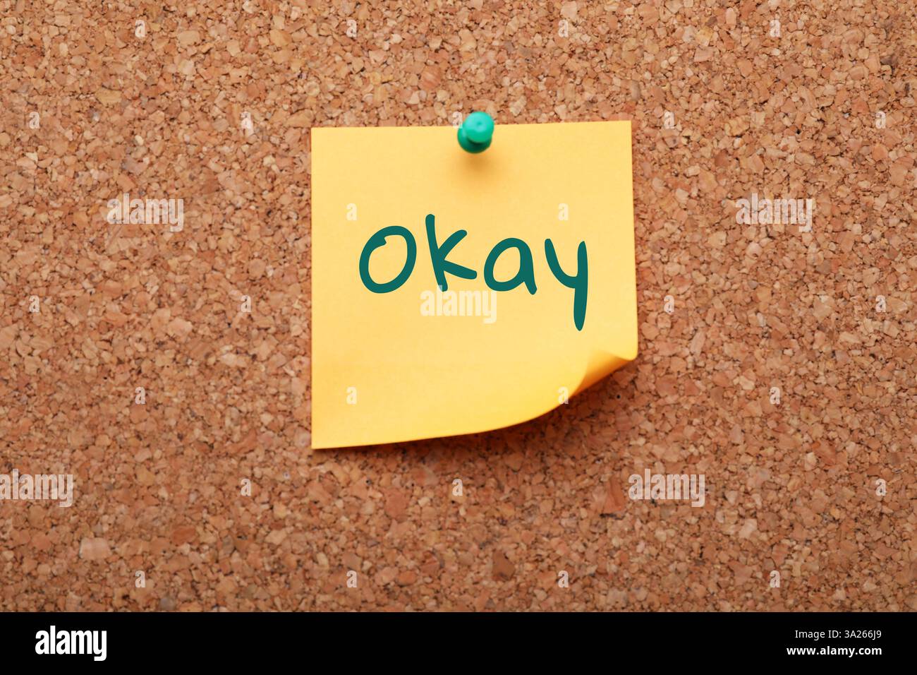 Paper note with word Okay pinned to cork background Stock Photo - Alamy