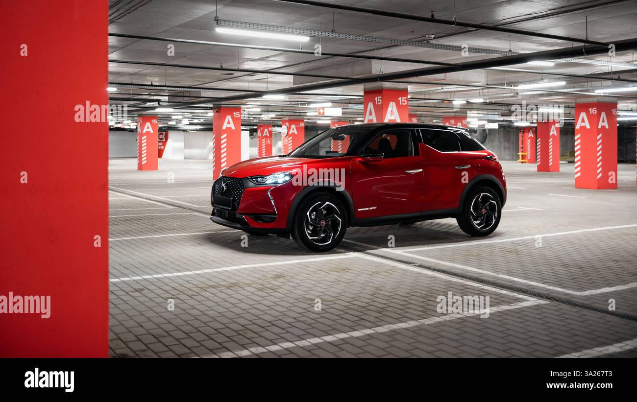 Red DS3 Crossback in underground parking garage. Compact car in empty ...