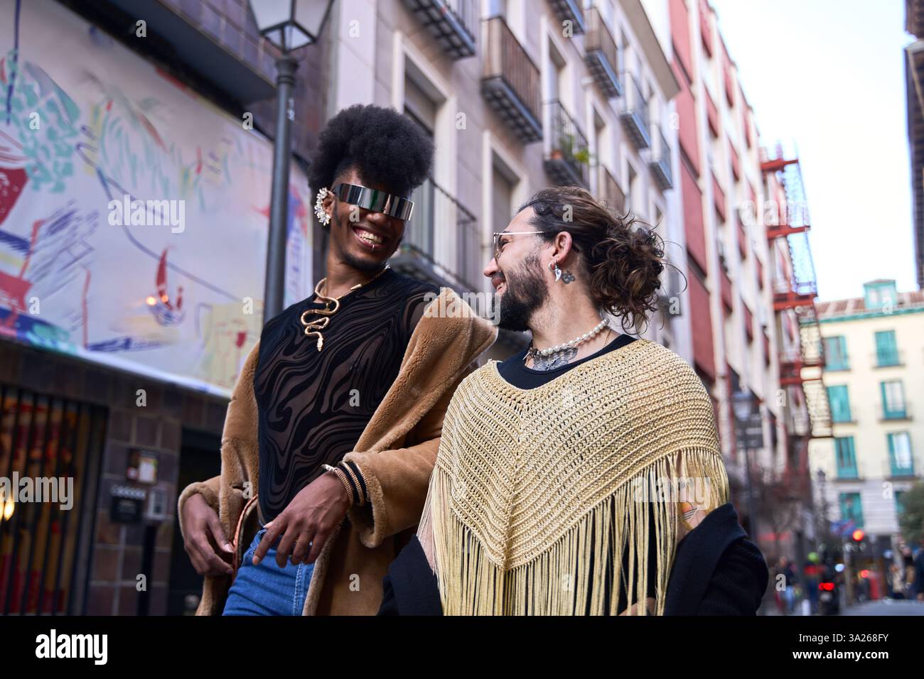 Two androgynous non binary people wearing modern clothes are walking ...