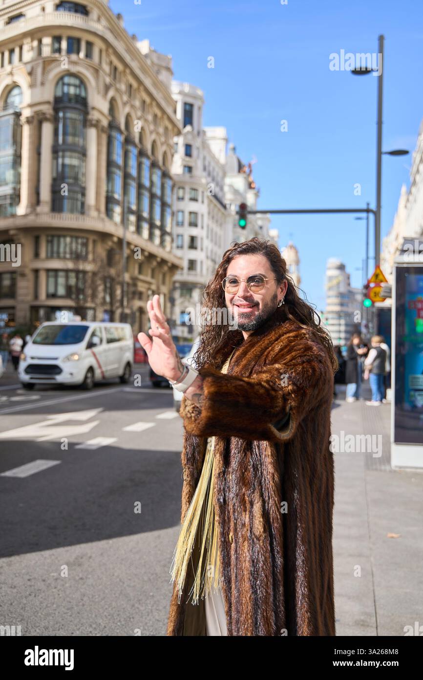 Latin transgender person wearing a stylish fur coat, happily waving ...